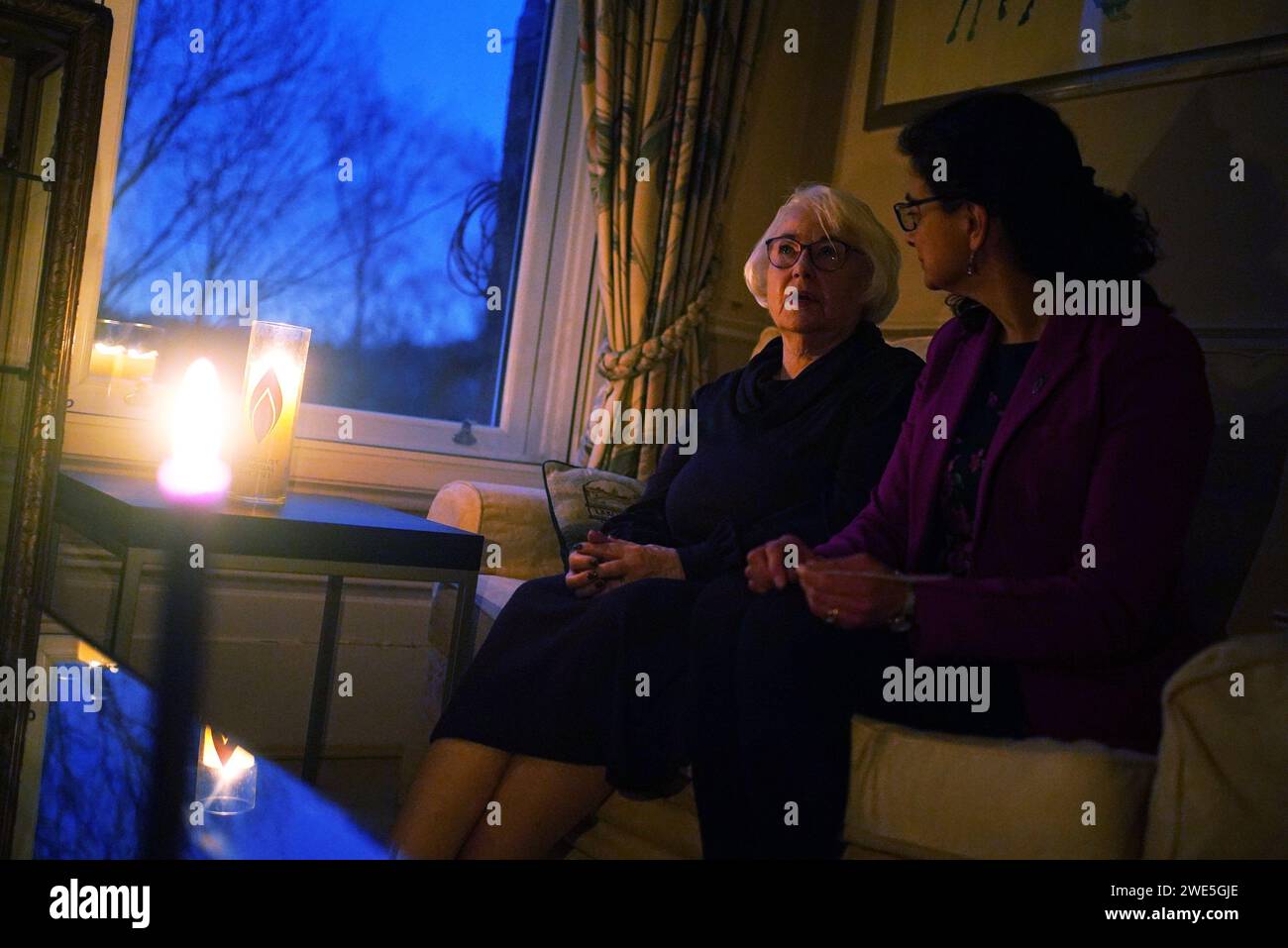 Holocaust survivor Joan Salter (left) lights a memorial candle at her ...