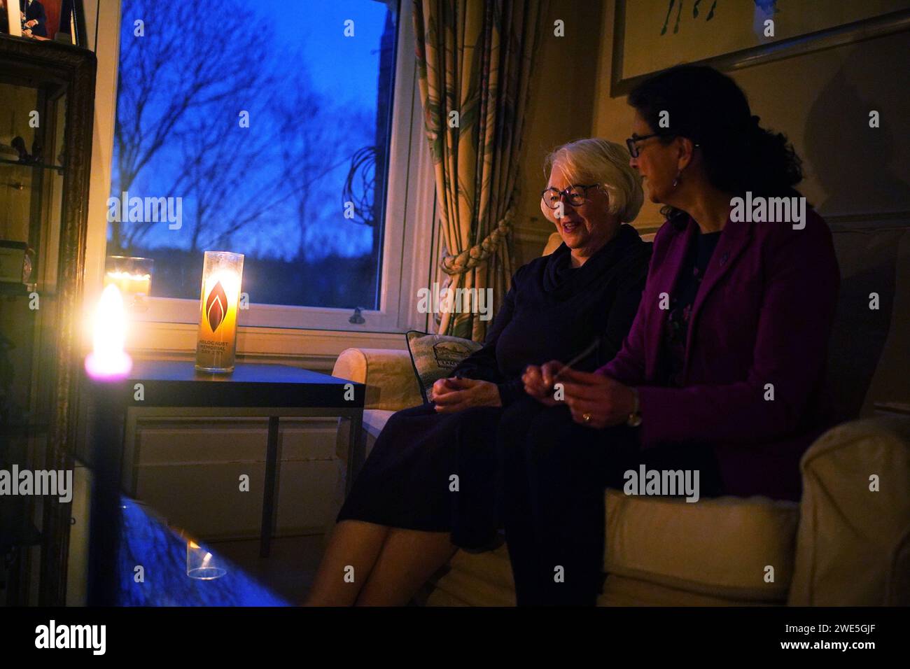 Holocaust survivor Joan Salter (left) lights a memorial candle at her ...