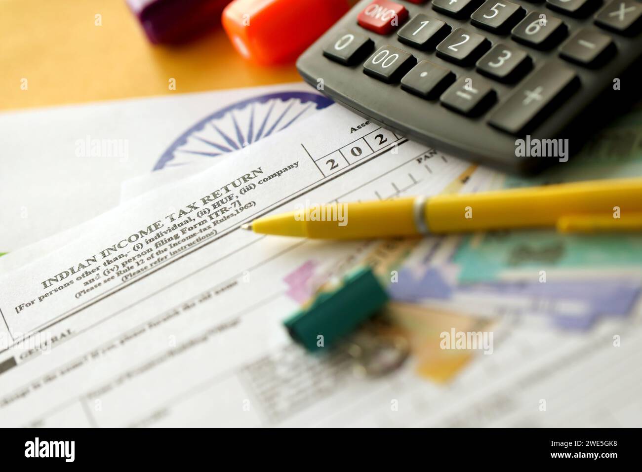 Indian income tax return blank form with pen and indian rupees bills on ...