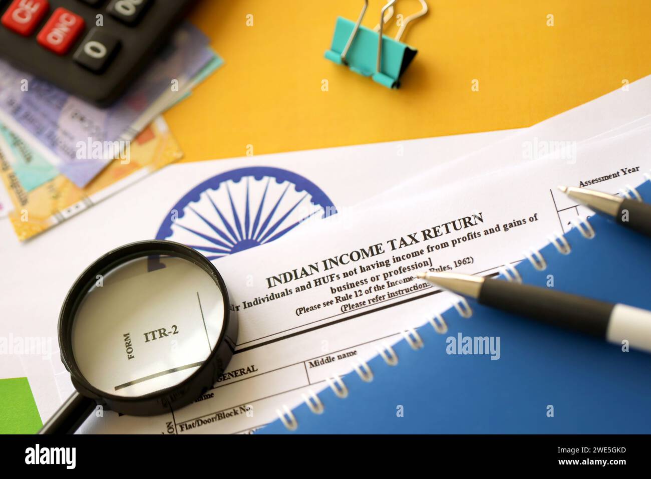 Indian income tax return blank form with pen and indian rupees bills on ...