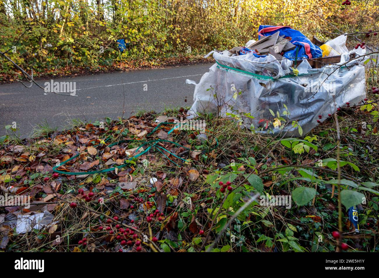 Large fly tipped bag of rubbish on the side of a country road Stock ...