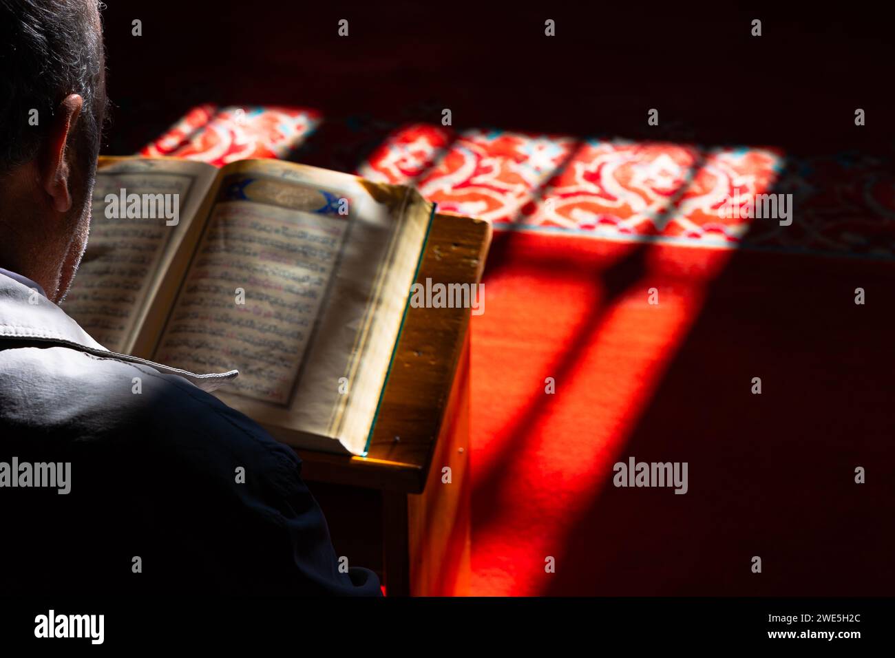 Islamic or ramadan background photo. Muslim man reading the Holy Quran ...