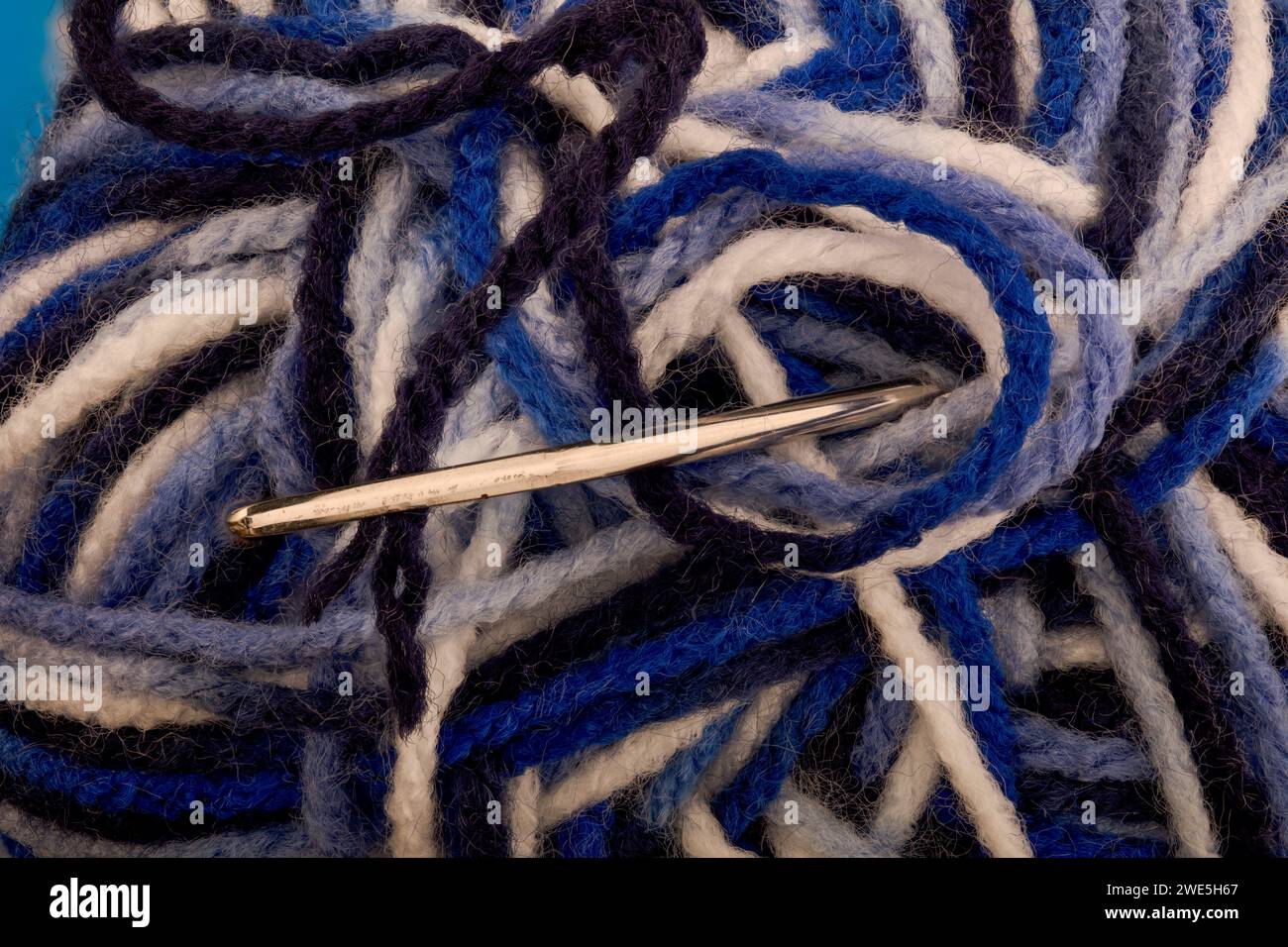 Very close up / macro still life image of patterned wool and needle ...