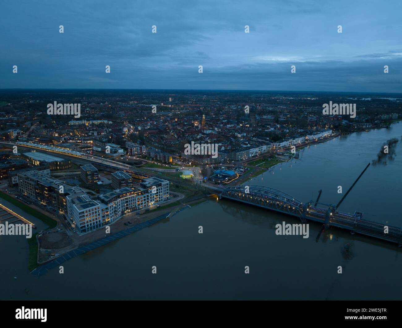 Aerial overview at dusk of the city of Zutphen, along the river Ijssel ...