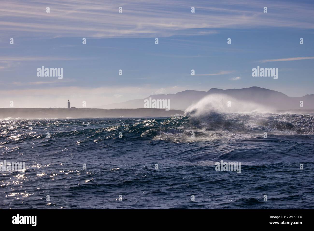 Breaking wave in the South Atlantic with a view of Danger Point ...