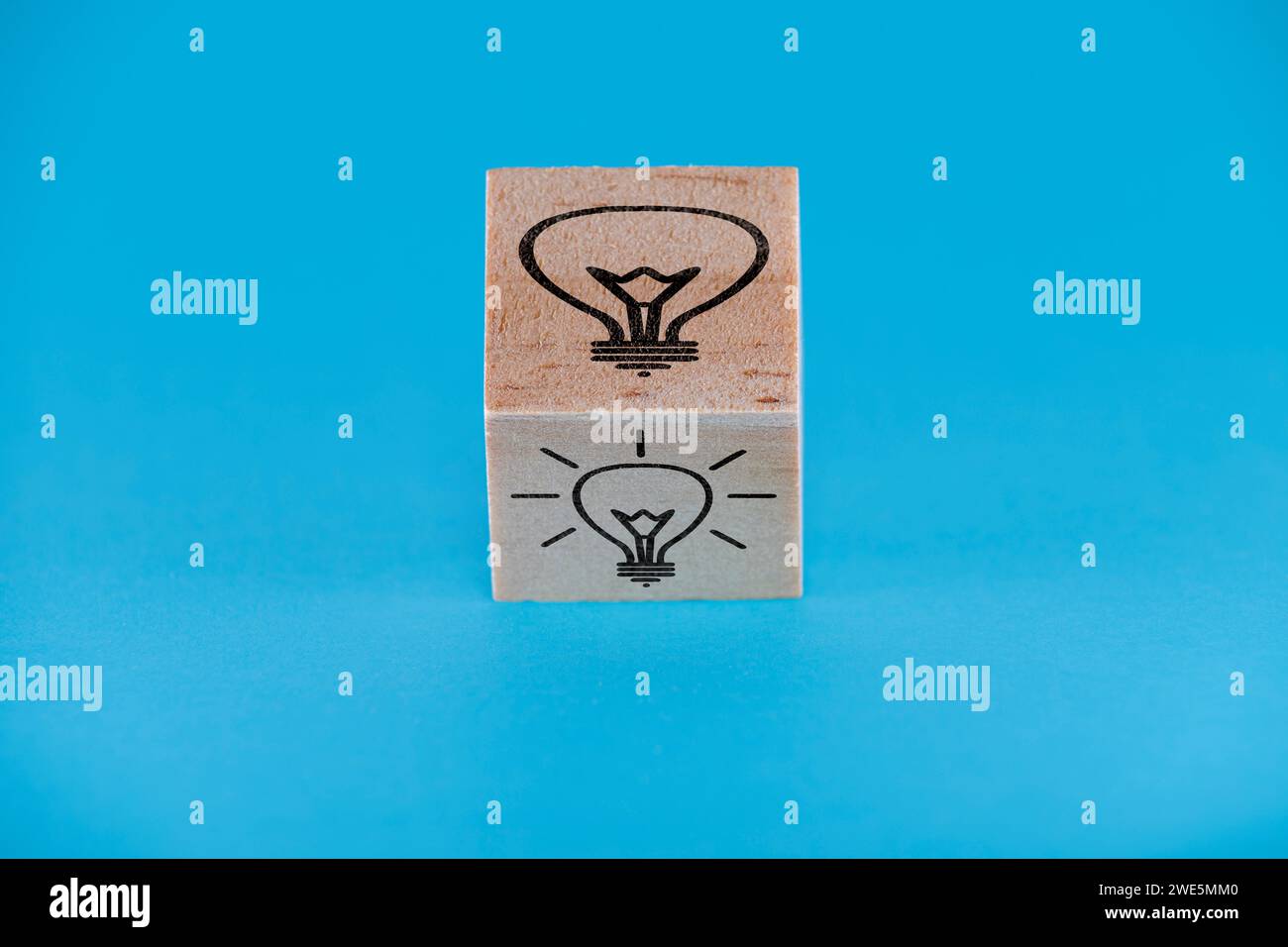 A single wooden block with a light bulb symbol printed on it, in a side ...