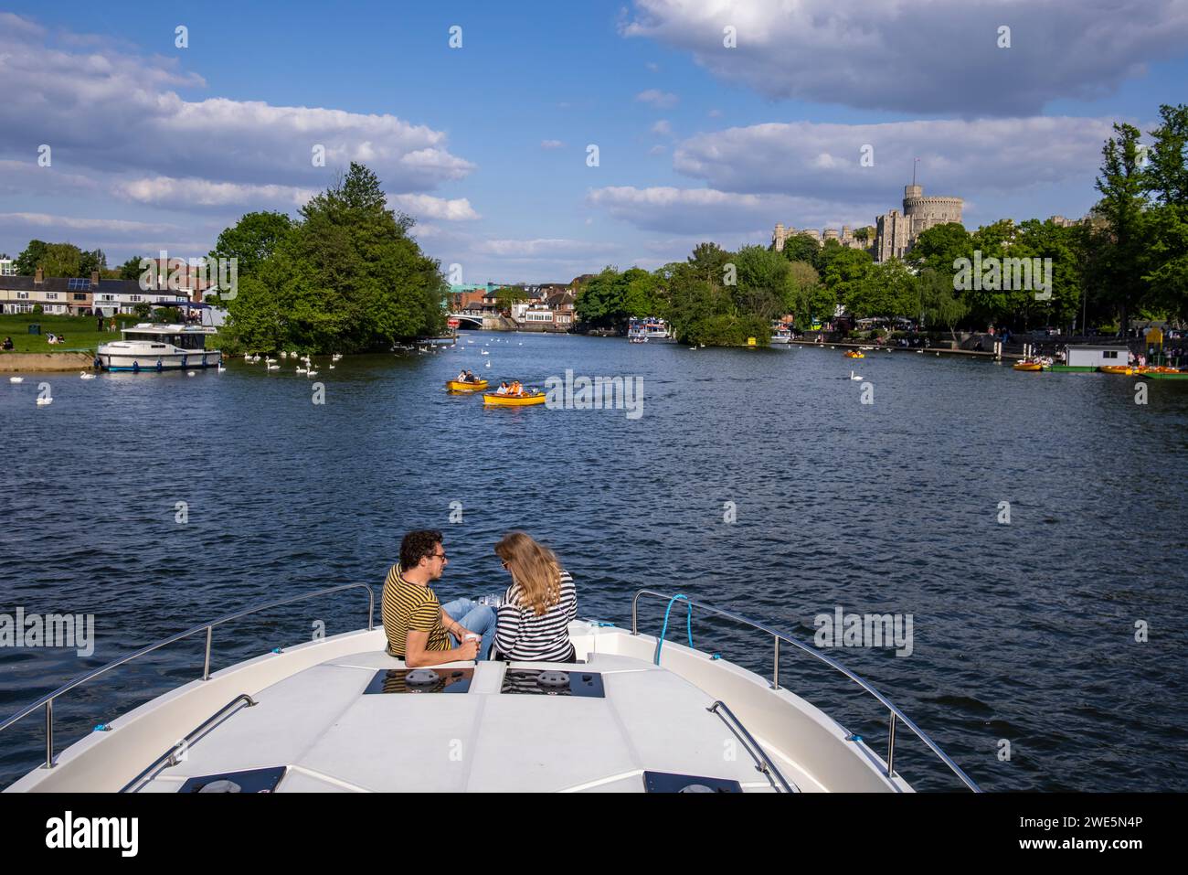 Couple on the bow of a Le Boat Horizon 4 houseboat on the River Thames ...