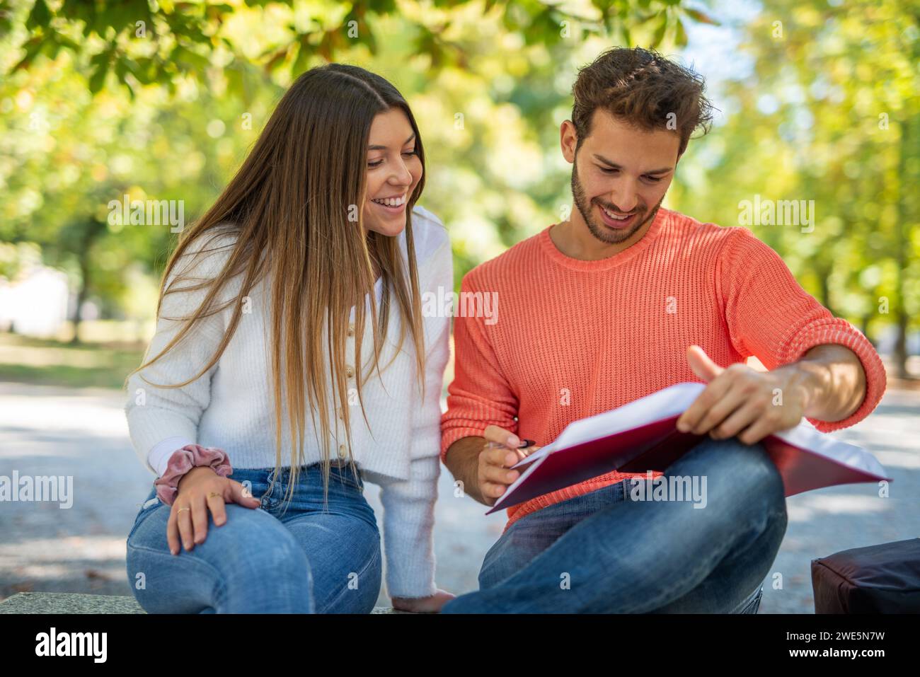 Group of students reading a book Stock Photo - Alamy