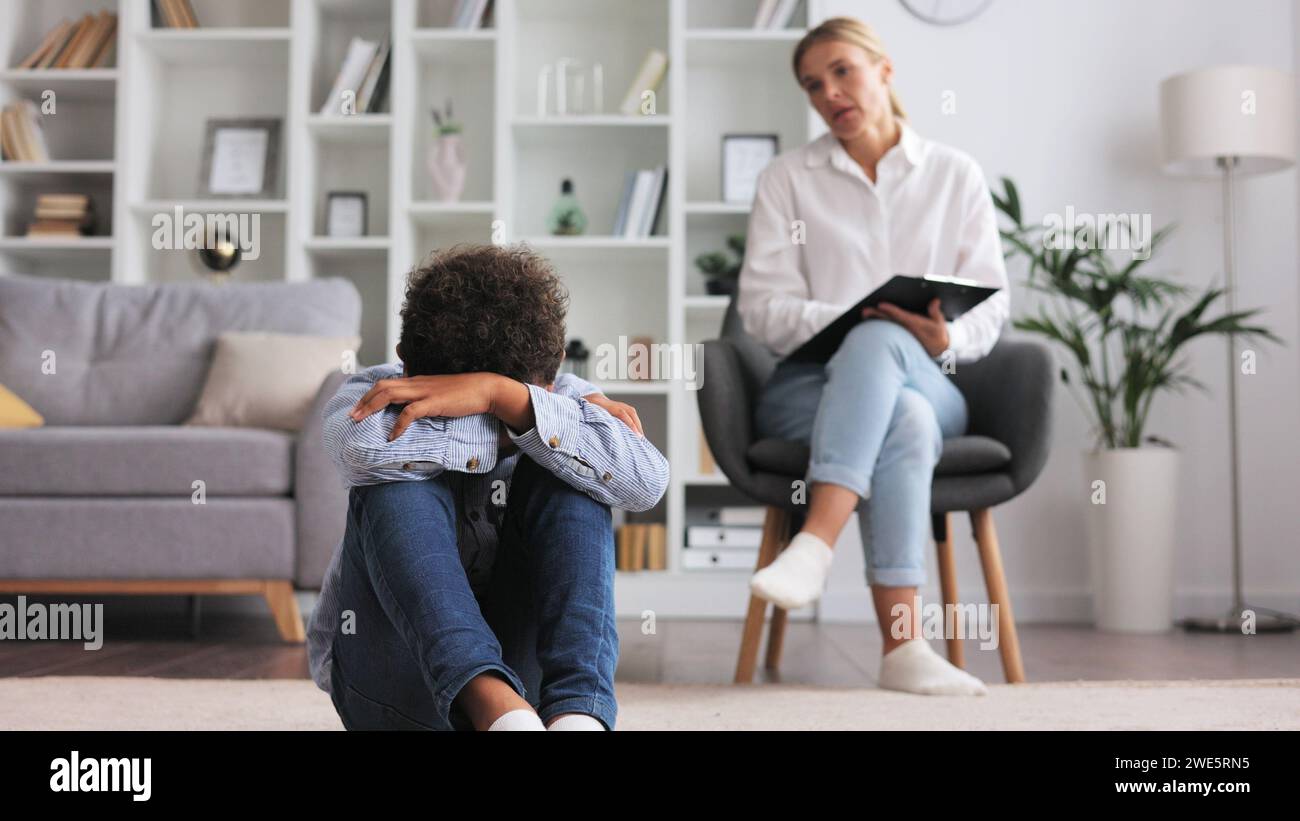 Disappointed little child in the psychologist office. Portrait of ...