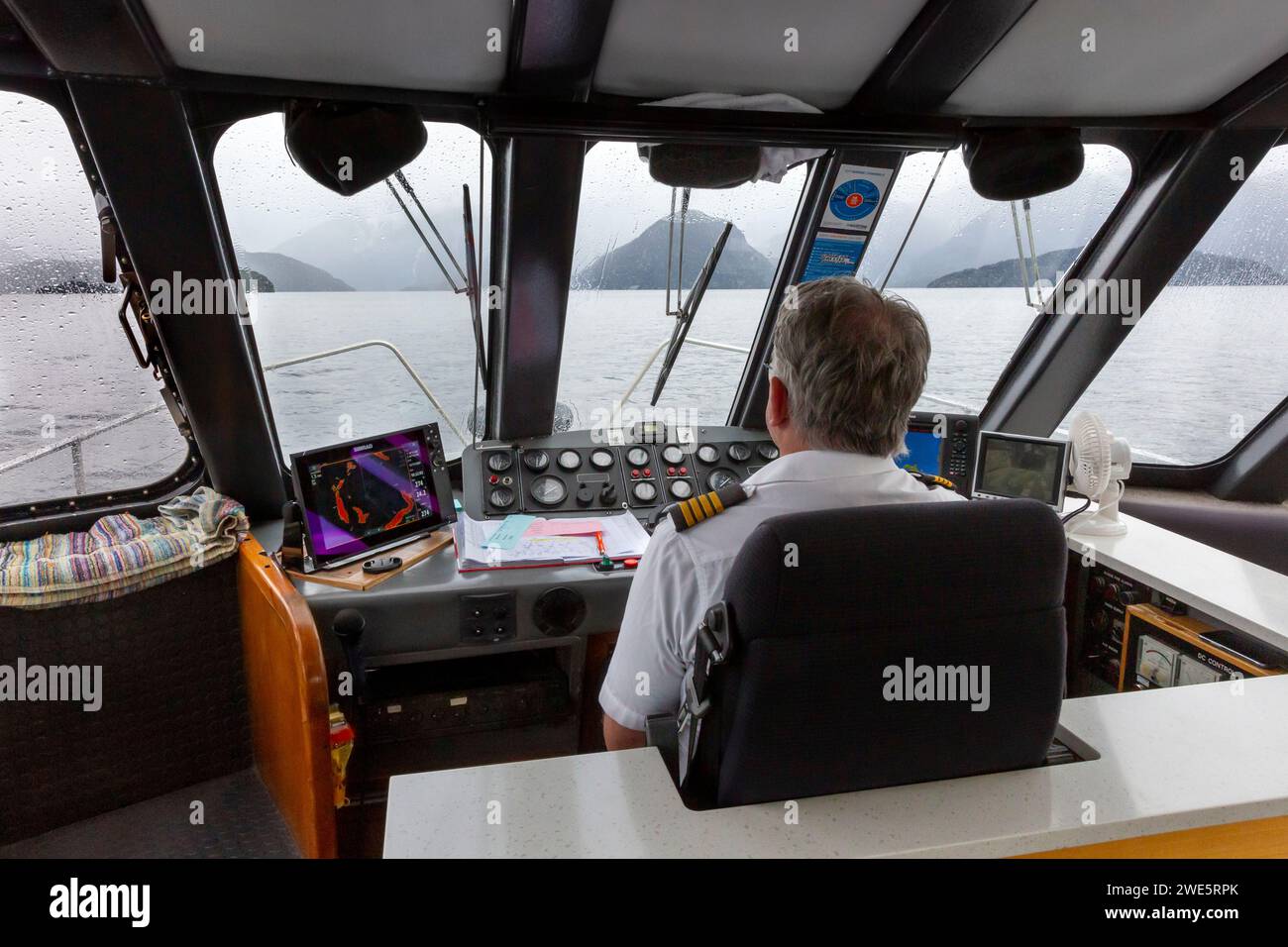 Ship’s captain guiding a Realnz catamaran passenger ferry on Lake ...