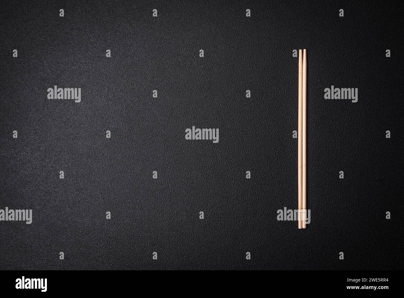 Light wooden chopsticks on a blank background as a backdrop for an ...