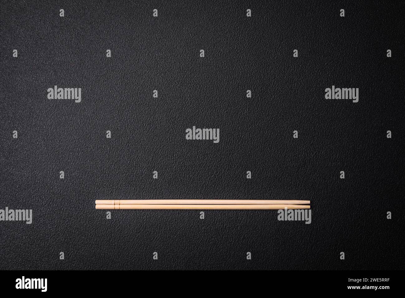 Light wooden chopsticks on a blank background as a backdrop for an ...