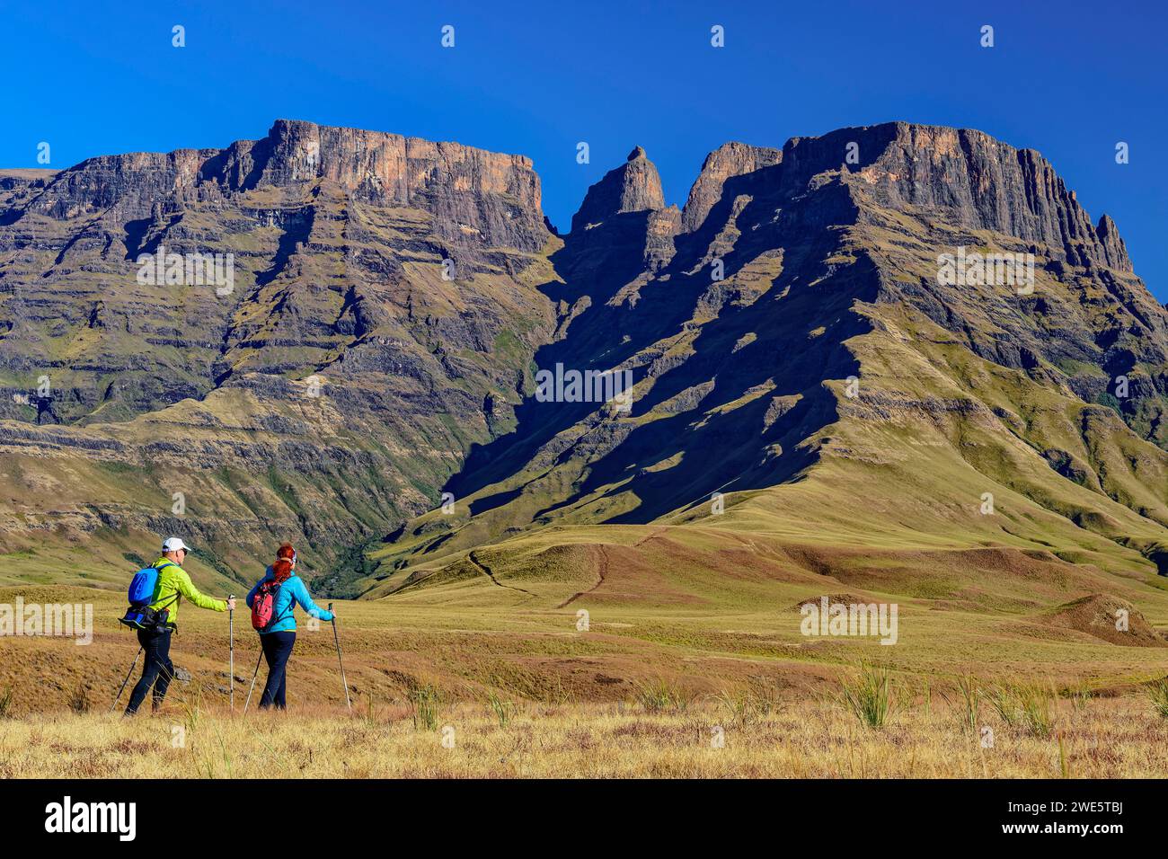 Man and woman hiking on Shada Ridge with Champagne Castle in the ...