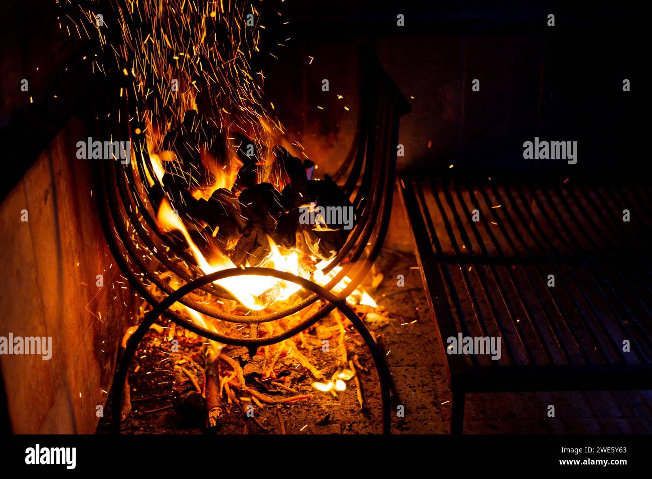 Lighting the fire for the barbecue. Burnt black charcoal igniting and ...