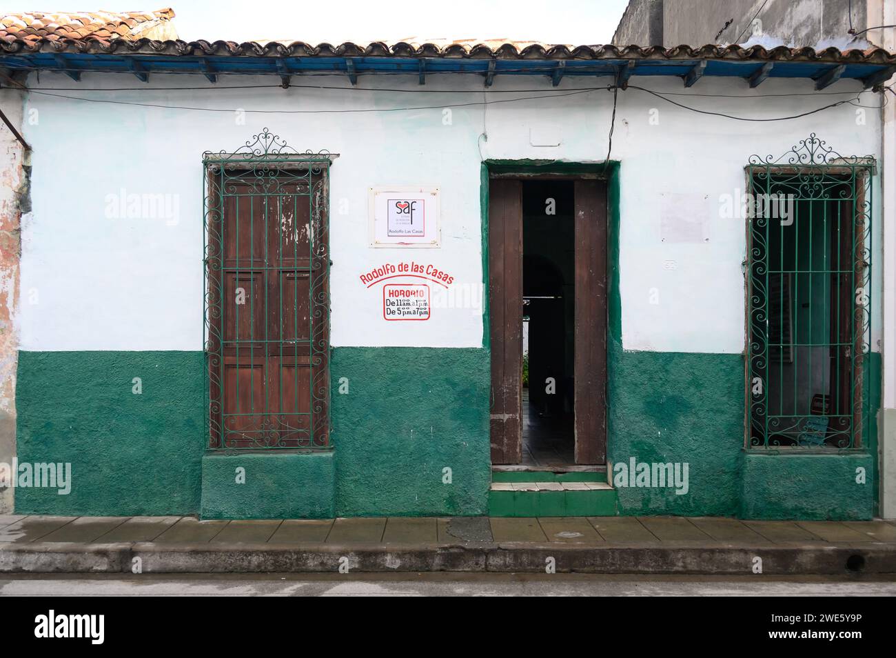 Facade and sign of a colonial building with a sign reading System of ...