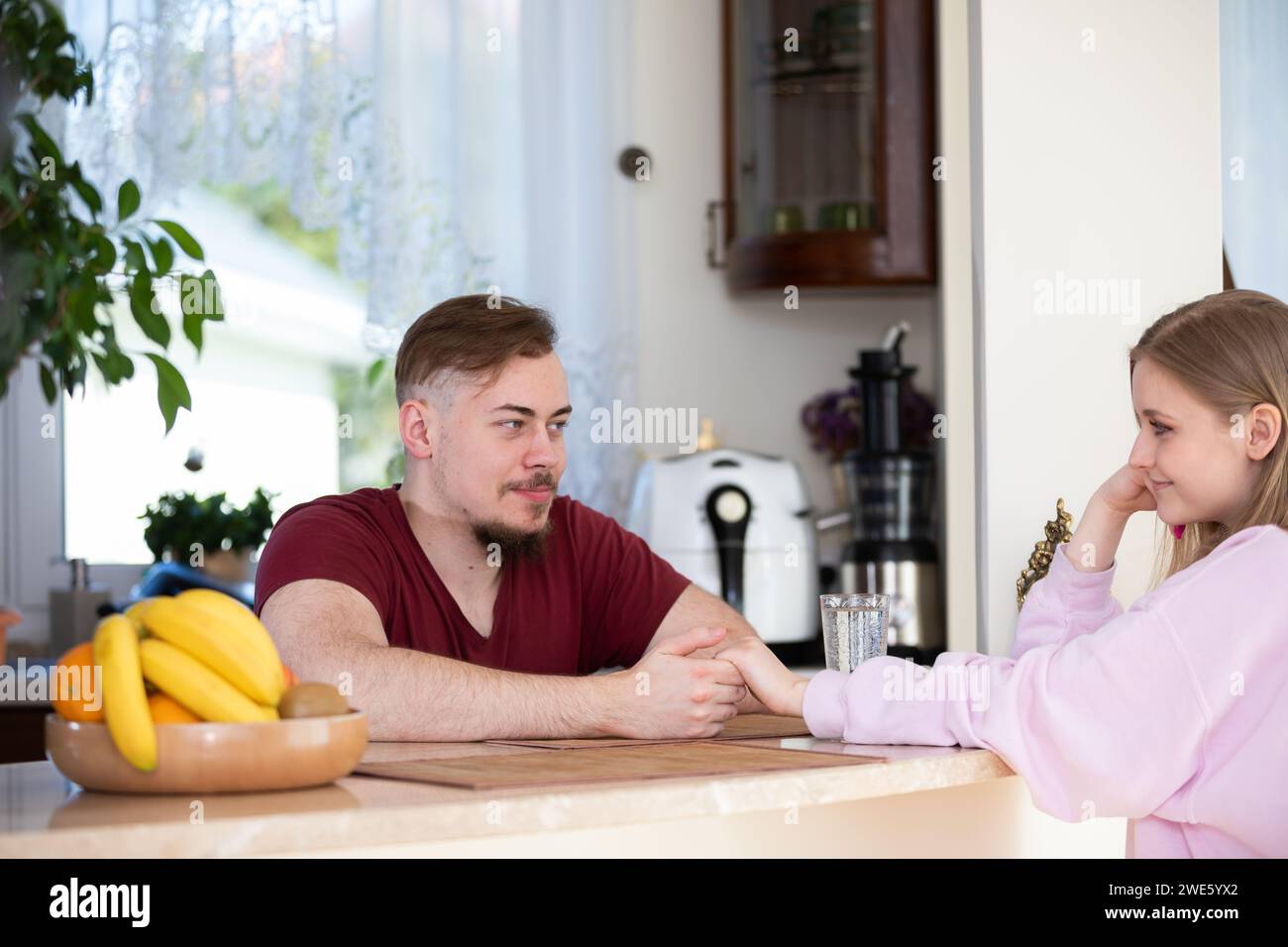 A couple in love sits across from each other and looks deeply into each ...