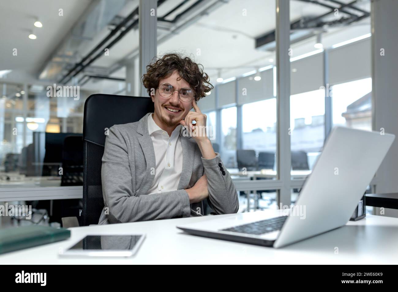 Adult male office worker displays professionalism and experience at his ...