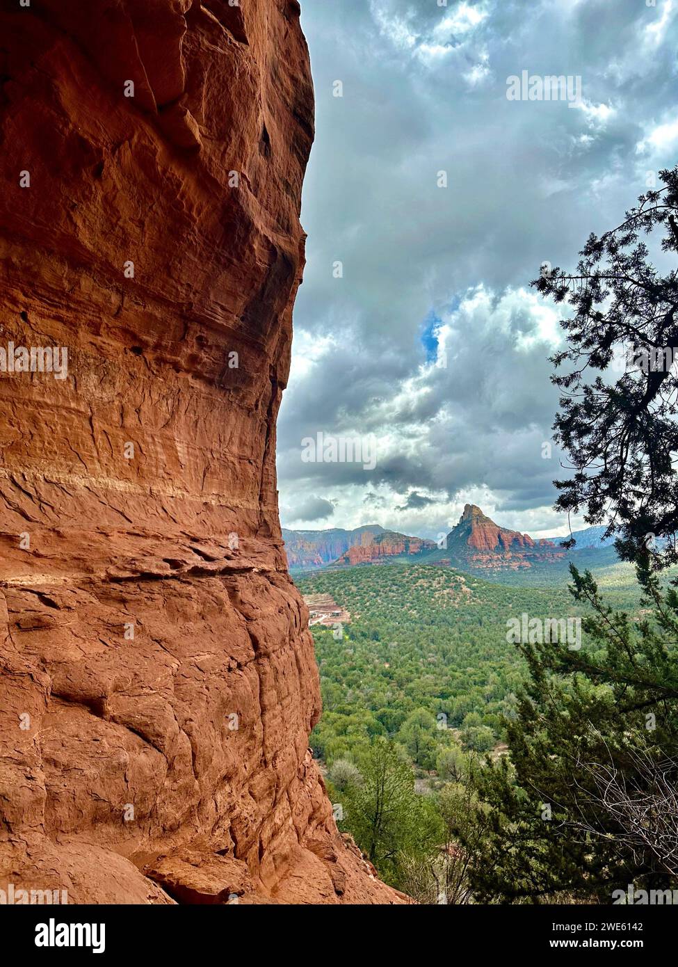 A majestic red rock standing tall in the distance, framed by the ...