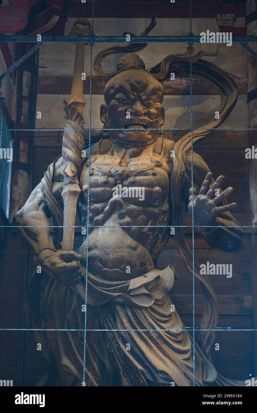 Close-up of a majestic human statue with a bird soaring by Stock Photo ...