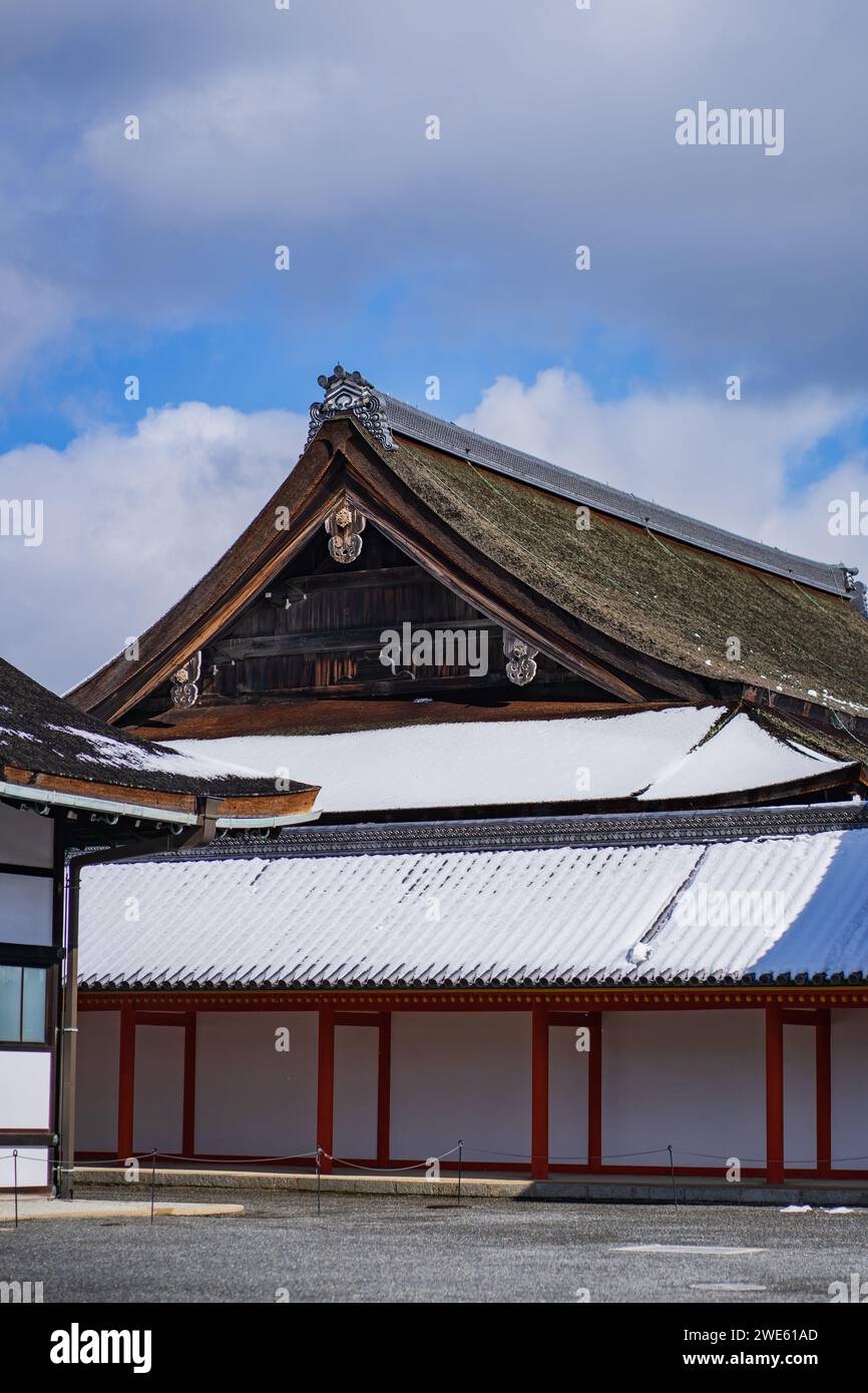 A colorful Asian building with distinct white and red roofs, featuring ...