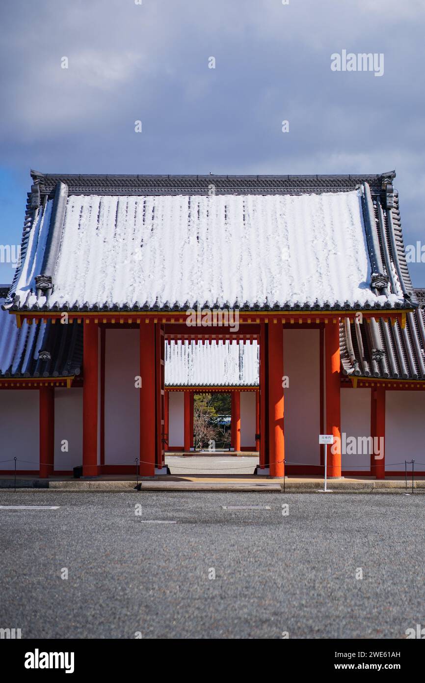 A colorful Asian building with distinct white and red roofs, featuring ...