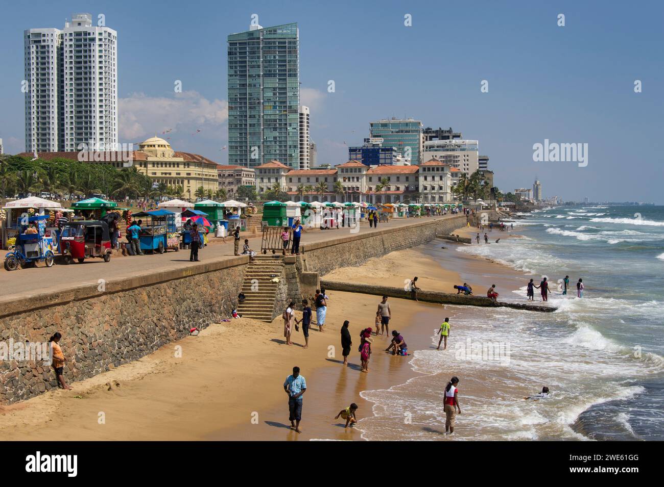 People at promenade, enjoying on beach in front of Galle Face Hotel ...