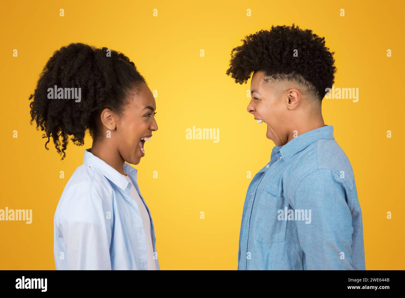 Sad African American young adults wearing casual clothing laugh ...