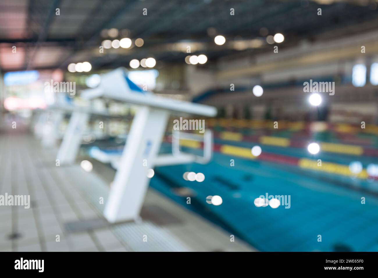 Defocused empty sport competition swimming pool with lanes, lens blur ...