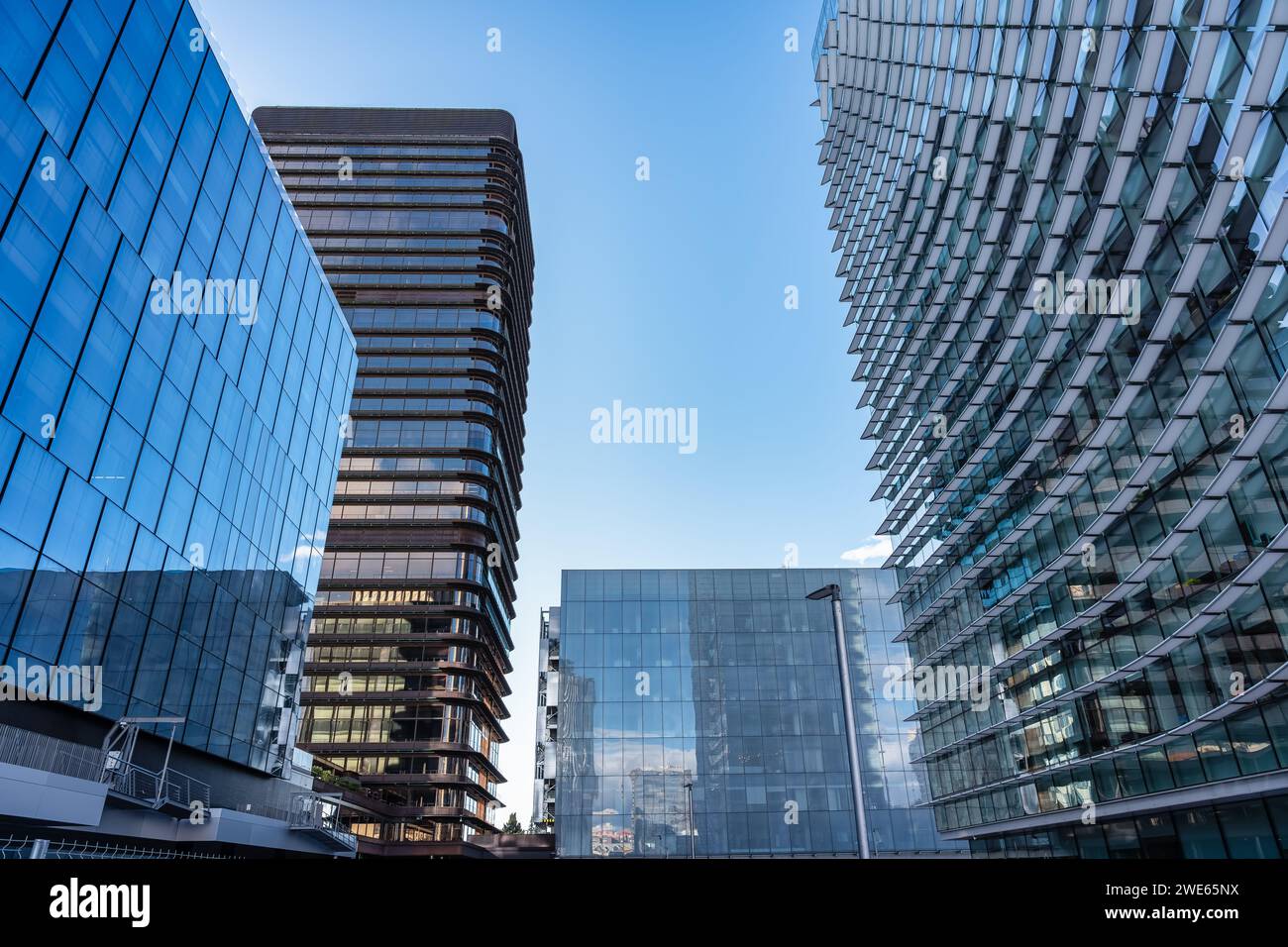 Modern office buildings that reflect other skyscrapers in Madrid in ...