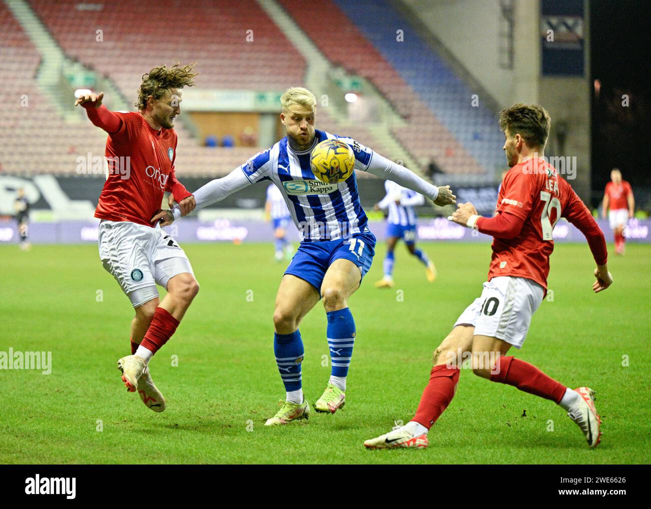 Stephen Humphrys of Wigan Athletic battles for the ball with Kieran ...