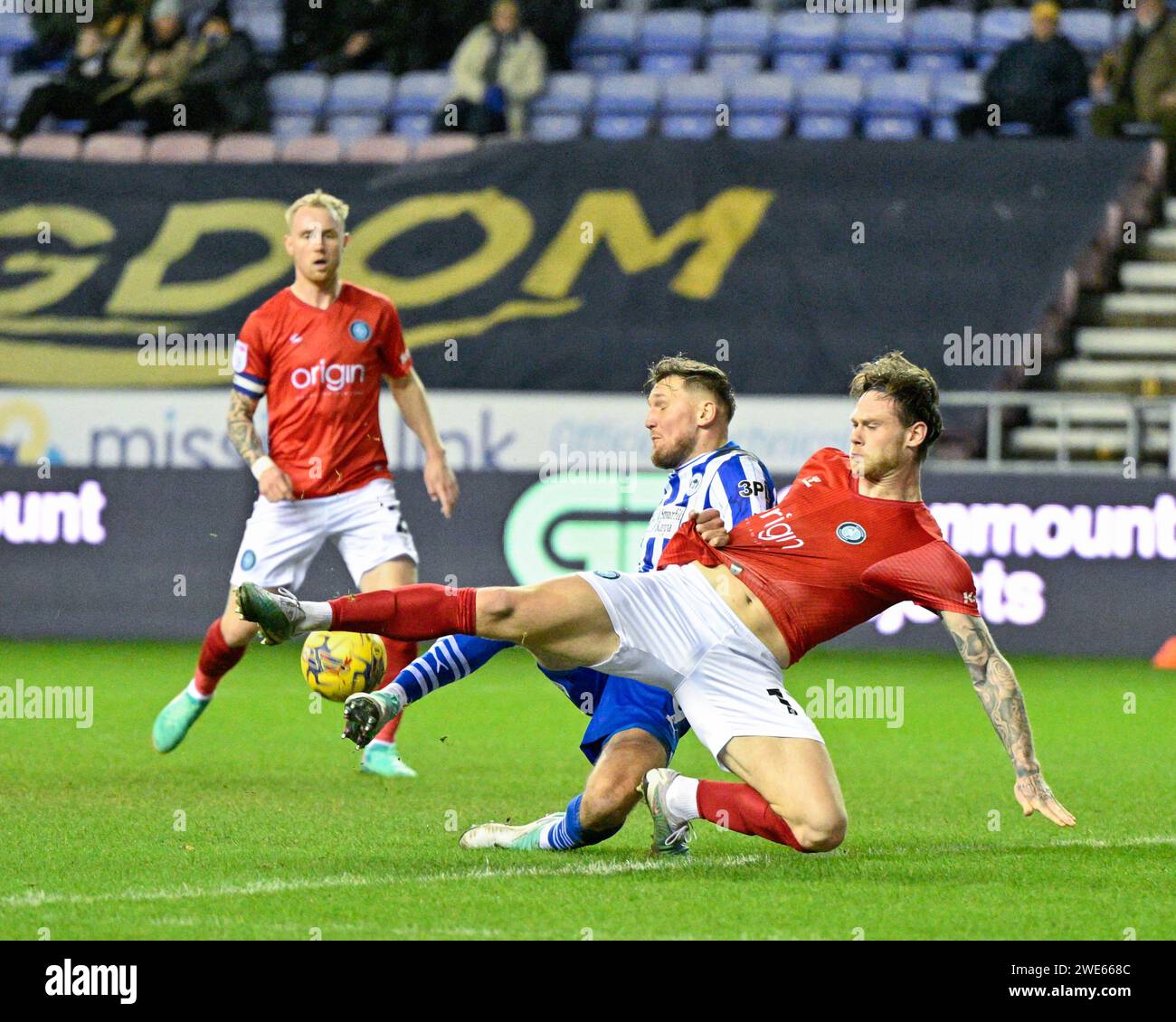 Joe Low of Wycombe Wanderers tackles Charlie Wyke of Wigan Athletic in ...