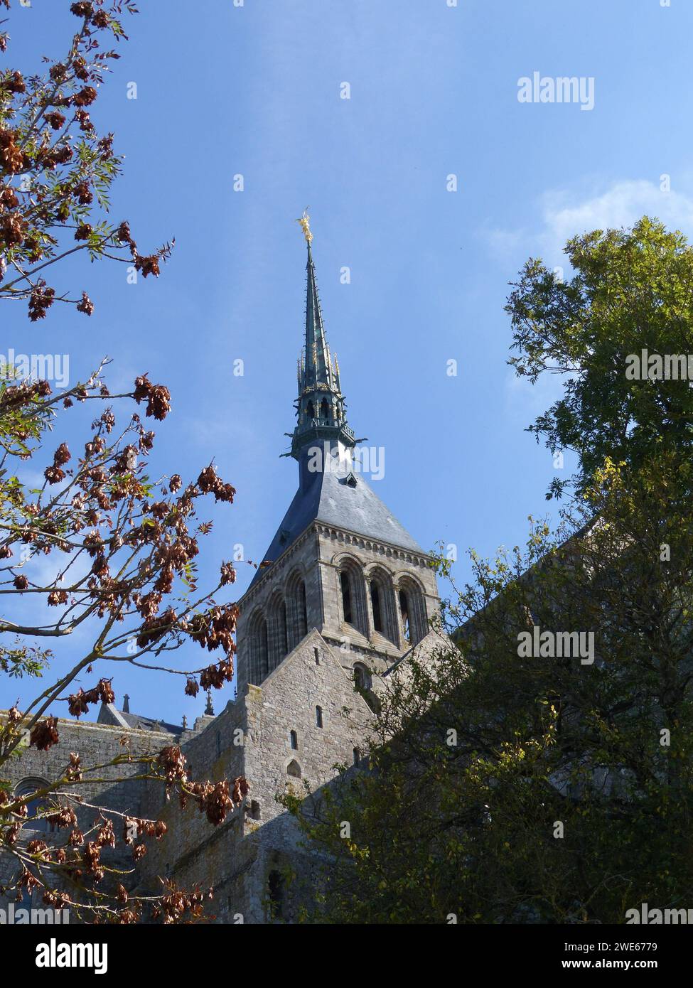 A majestic building featuring a steeple and clock tower atop Stock ...