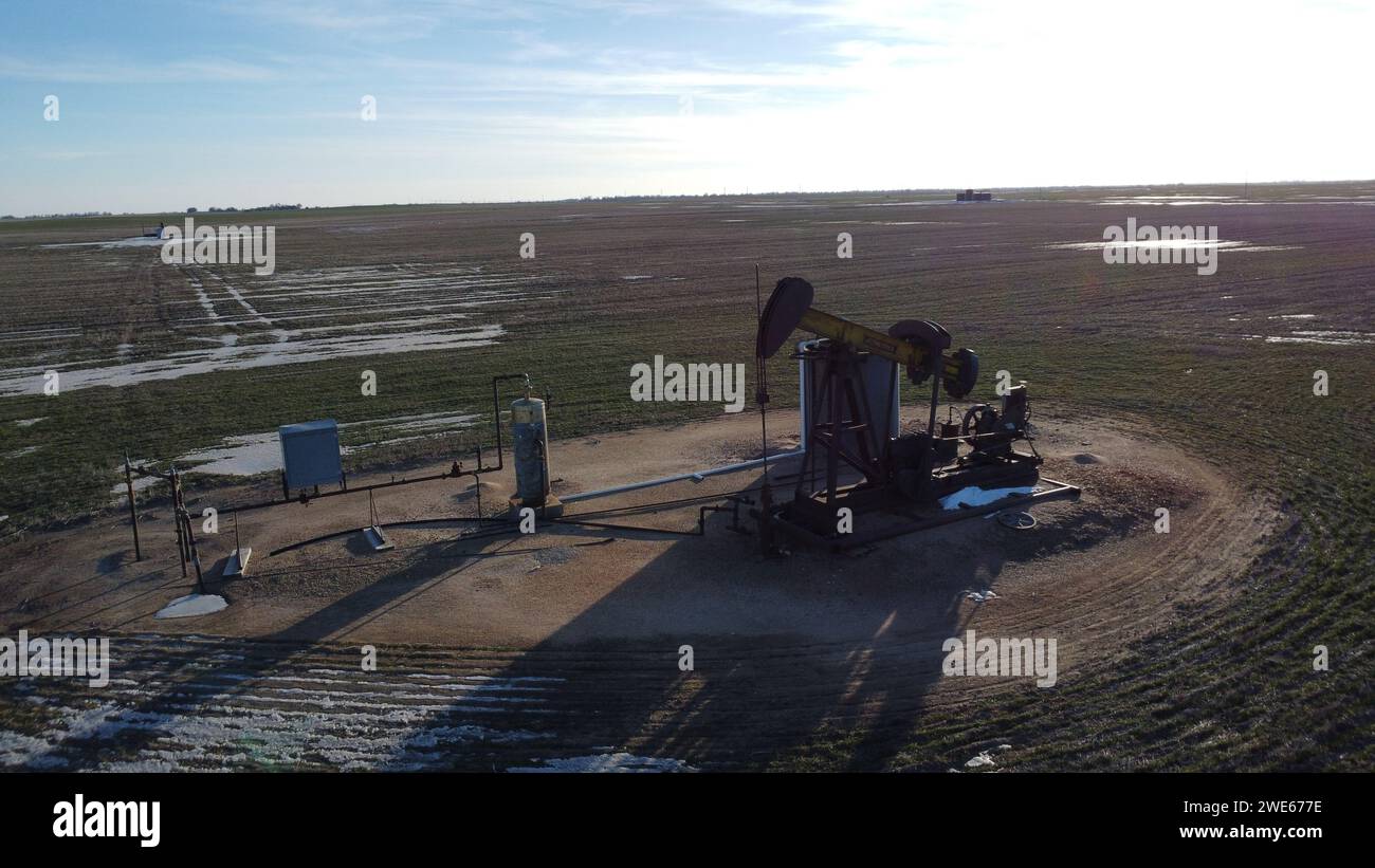 An isolated oil drilling site situated in a remote, desolate location ...