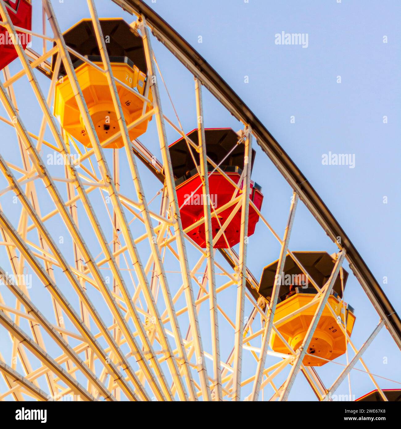 Red and yellow ferris wheel against blue sky hi-res stock photography ...