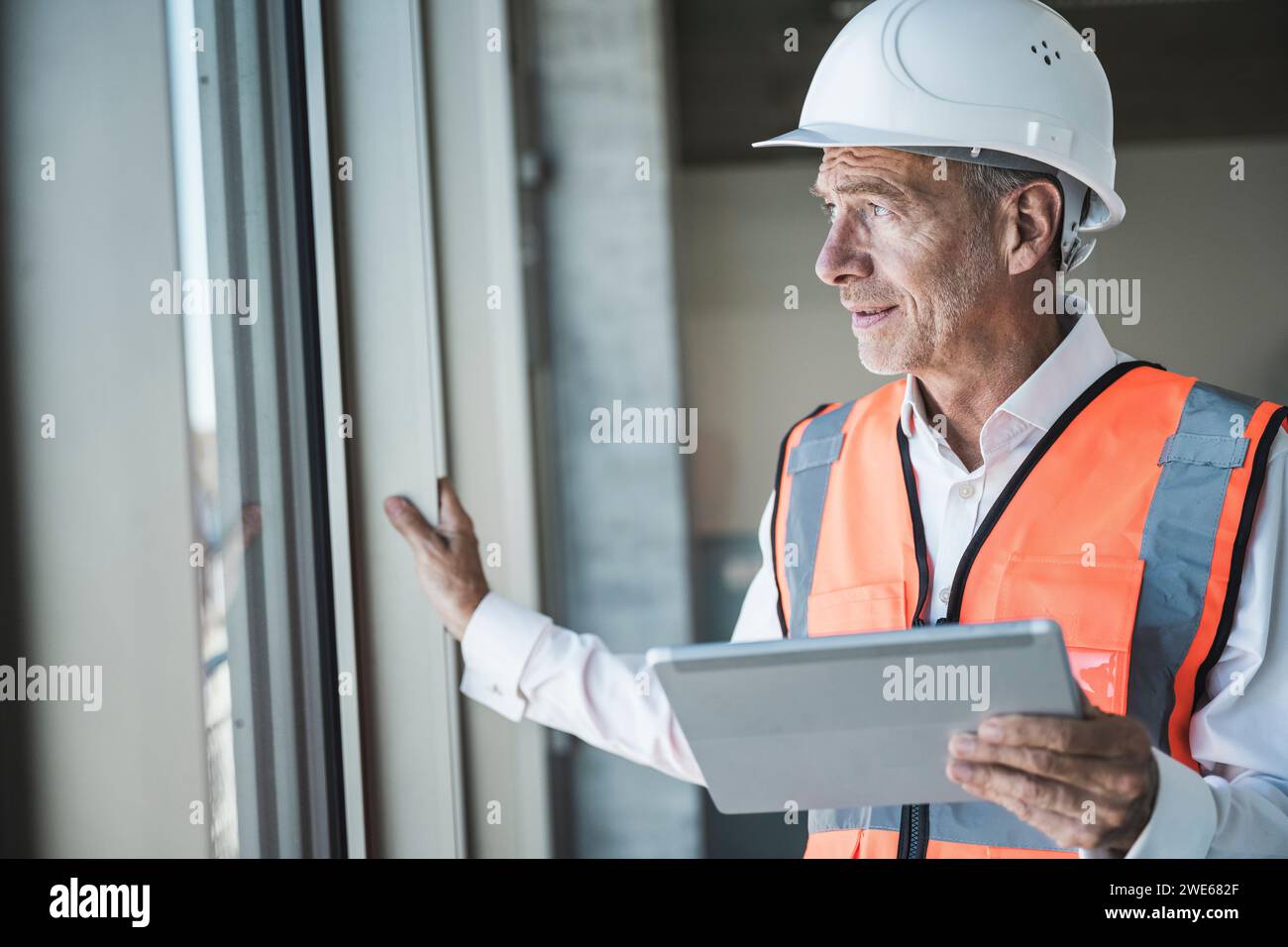 Senior architect standing window hi-res stock photography and images ...