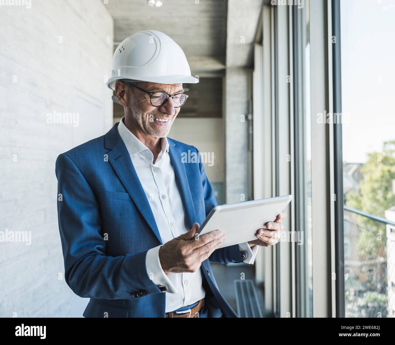 Senior architect standing window hi-res stock photography and images ...