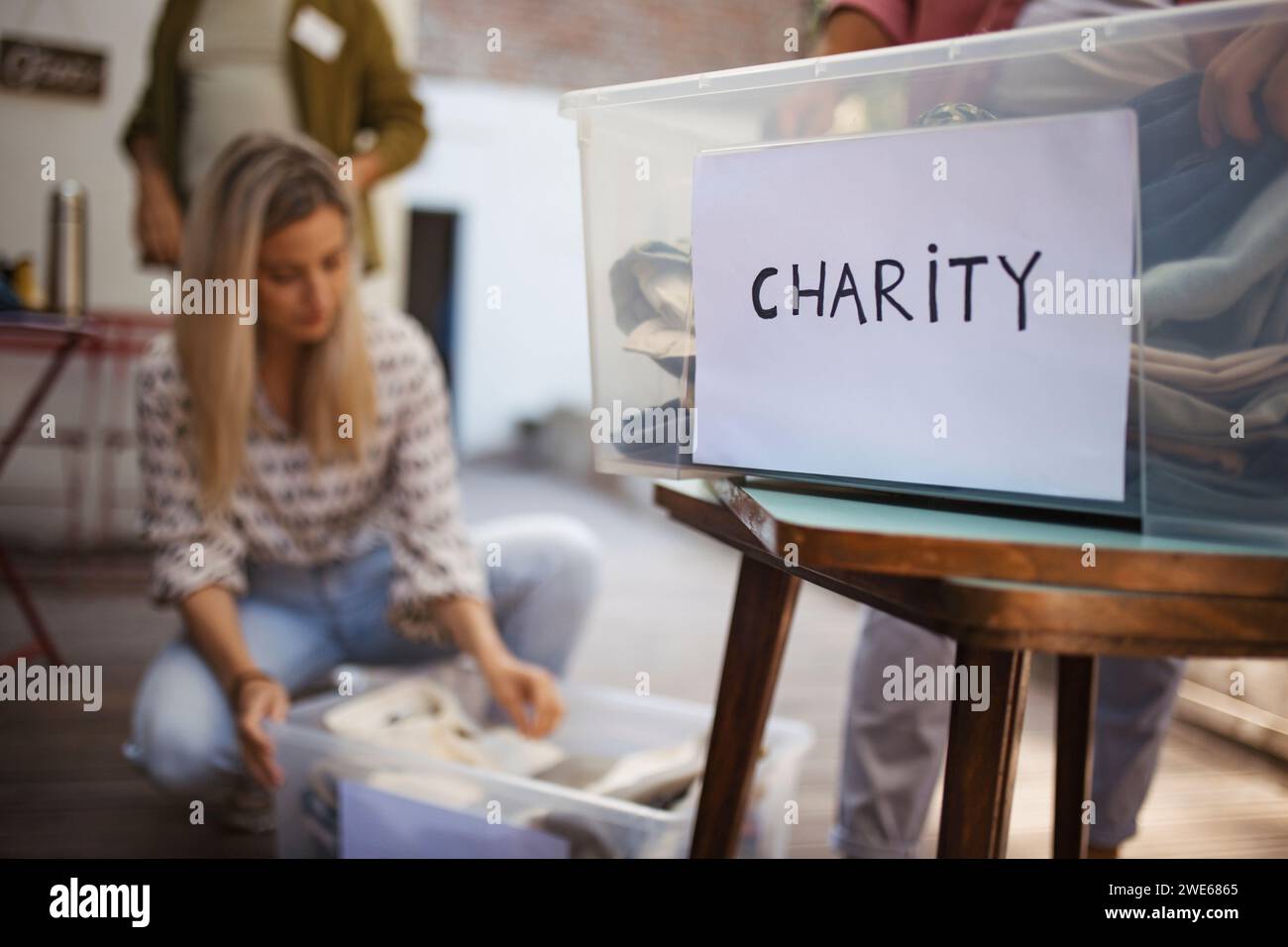 People collecting and sorting clothes for charity Stock Photo - Alamy