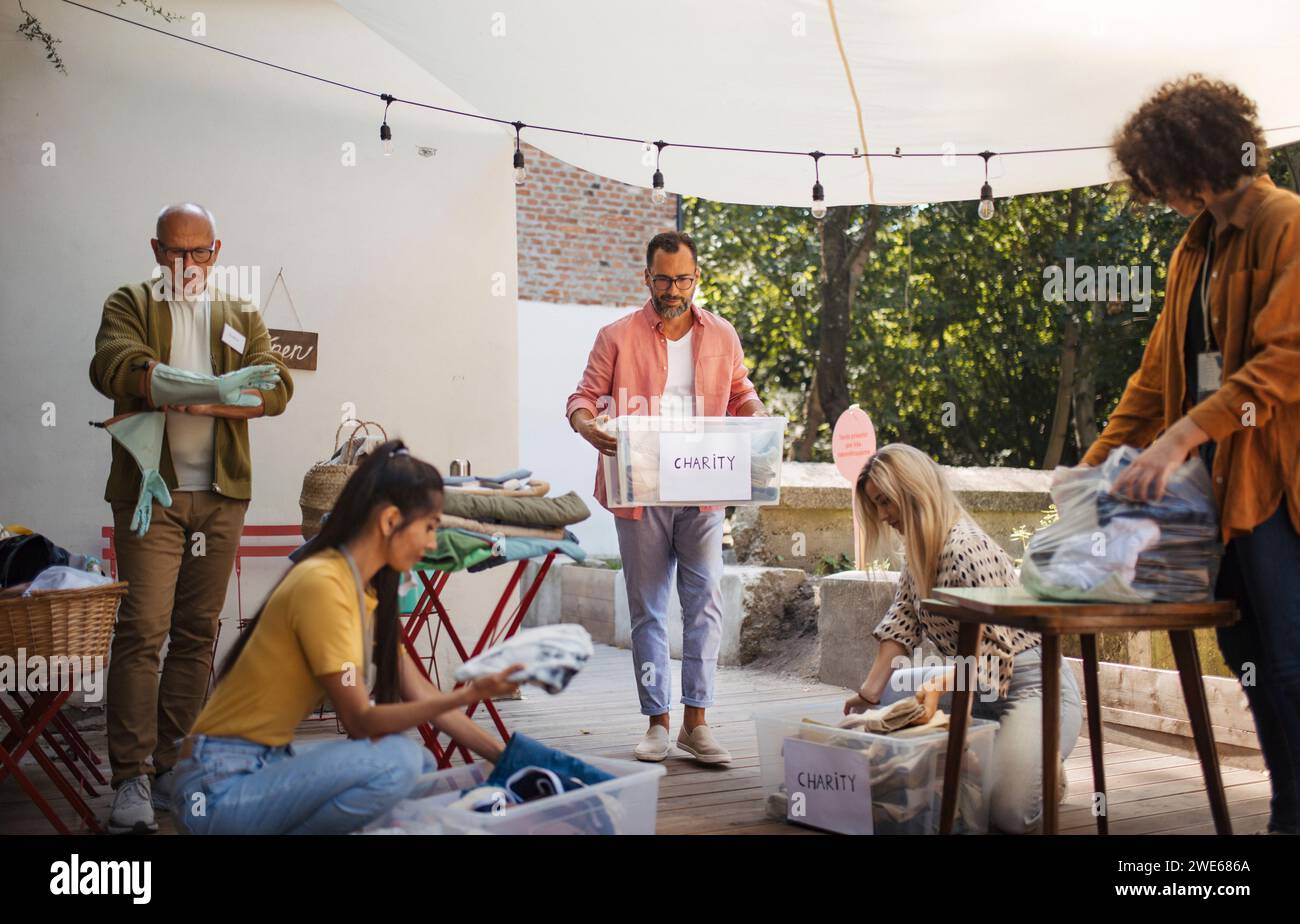 People collecting and sorting clothes for charity Stock Photo - Alamy