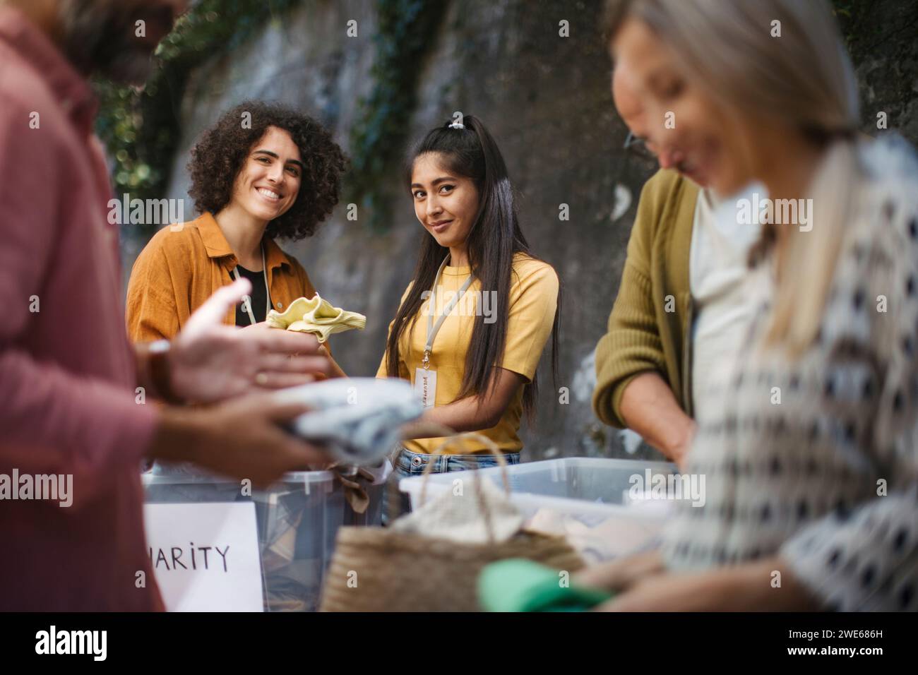 People donating and collecting clothes for charity Stock Photo - Alamy