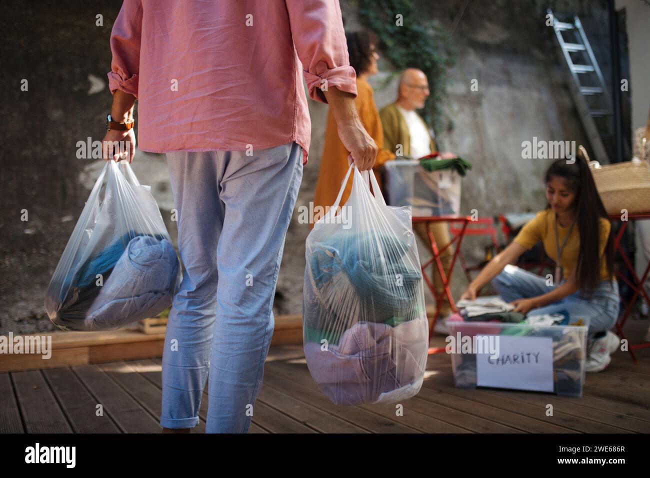 People sorting used clothes for charity Stock Photo - Alamy