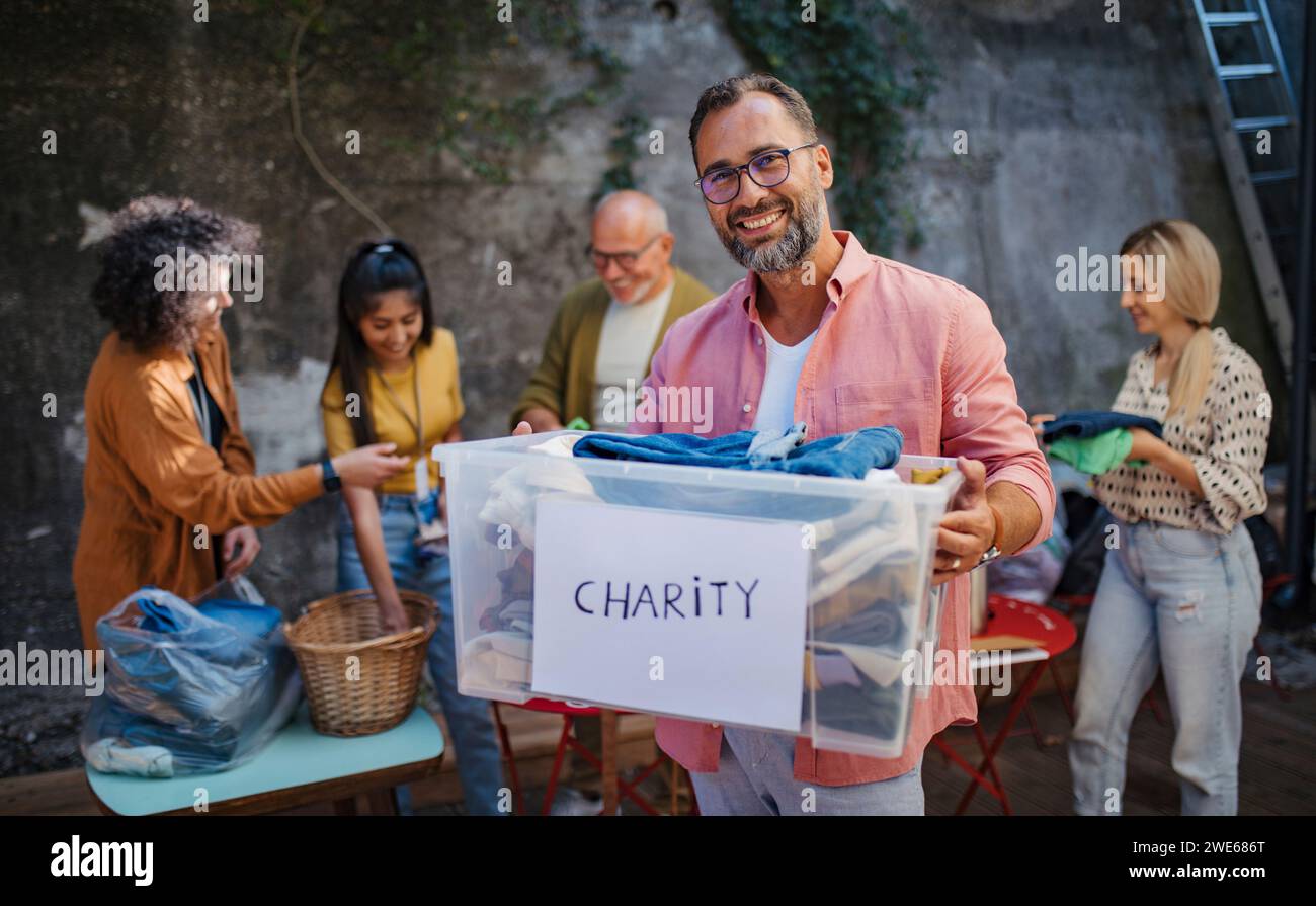 People donating and collecting clothes for charity Stock Photo - Alamy