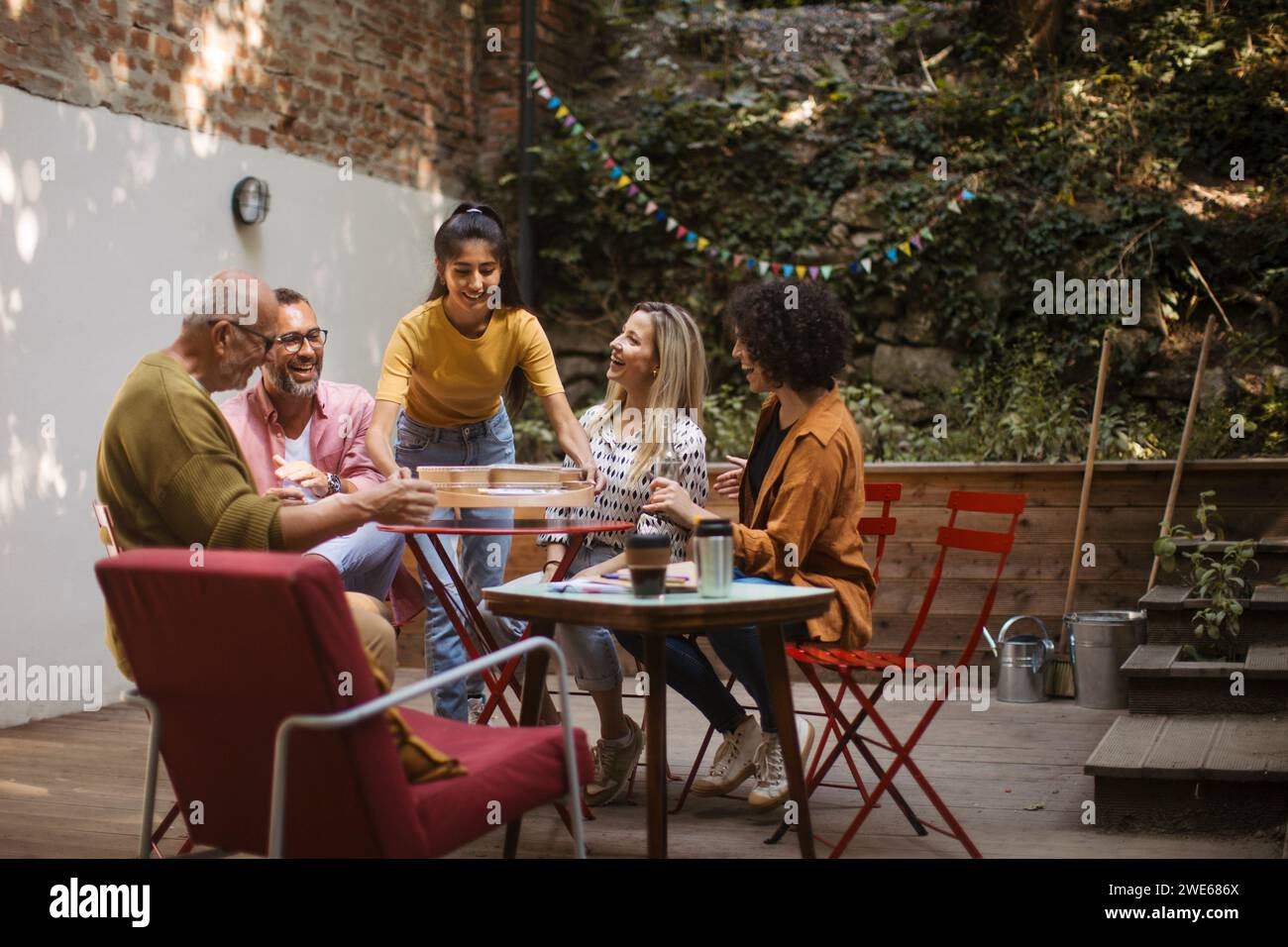 Volunterrs eating together in community garden after meeting Stock ...
