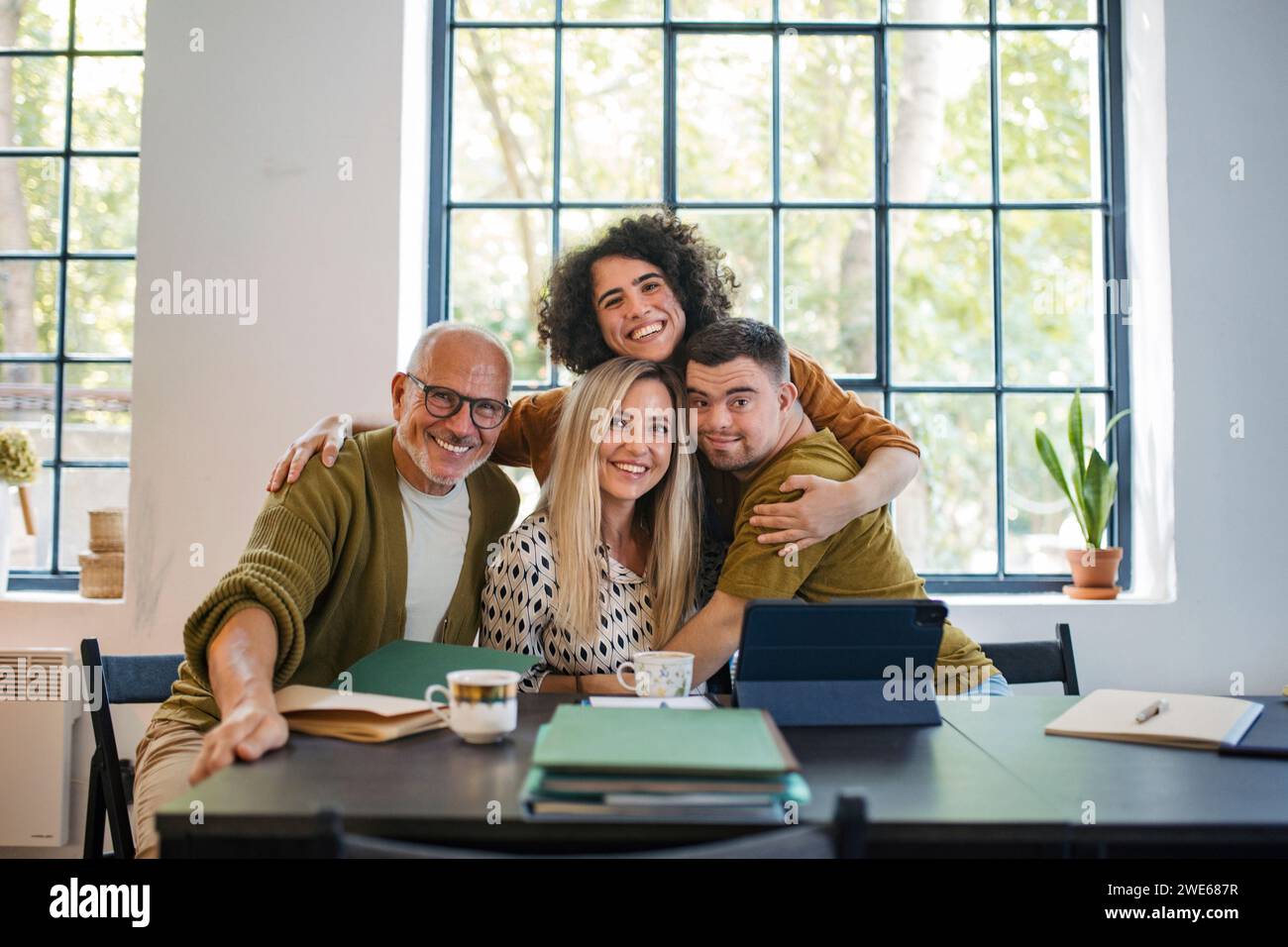 Person with disability working with colleagues in inclusive community ...