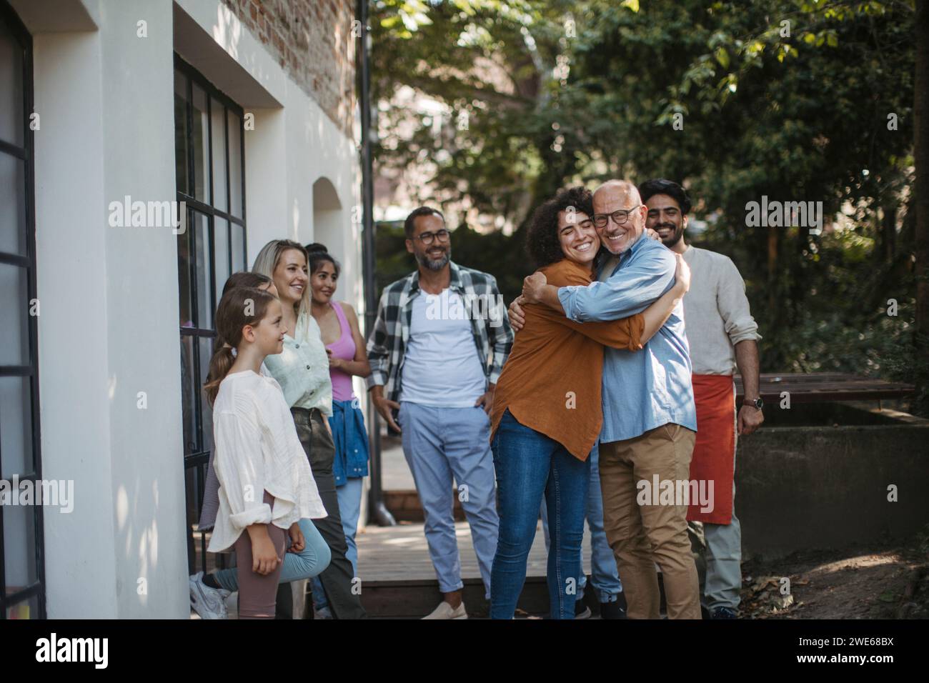 Diverse group of community members embracing successful community ...