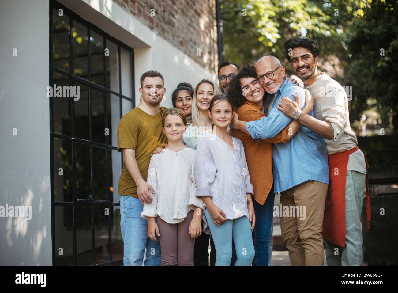 Diverse group of community members embracing successful community ...