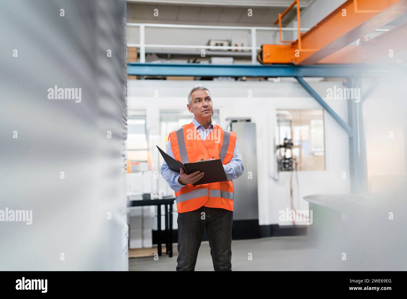 Engineer preparing checklist near machinery in factory Stock Photo - Alamy