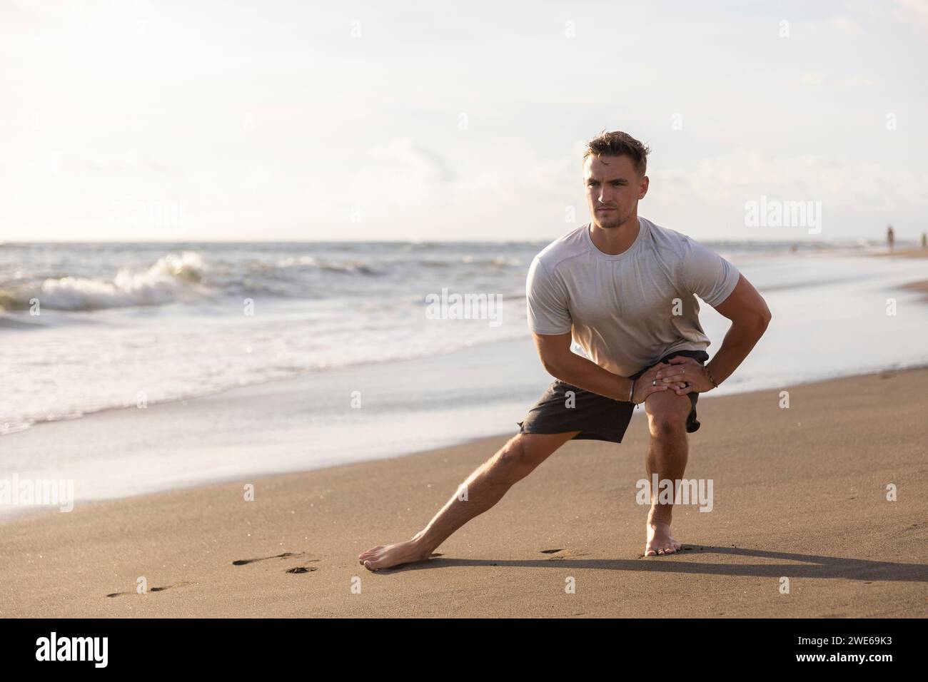 Young man doing stretching hi-res stock photography and images - Alamy