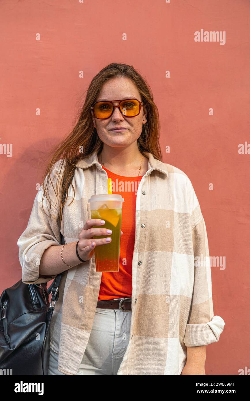 Woman holding her backpack hi-res stock photography and images - Alamy