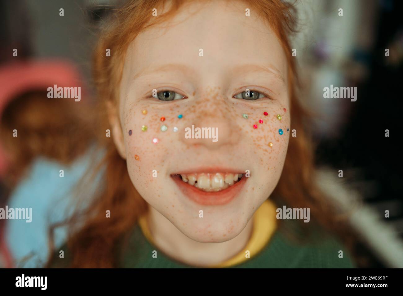 Happy redhead girl with sequins on face Stock Photo - Alamy