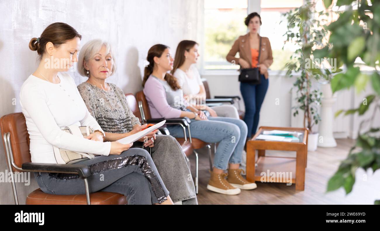 Young female employees sits in waiting room and waits for interview ...
